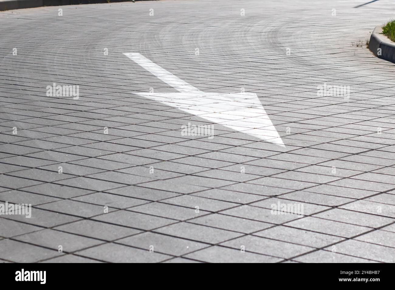 A large white arrow, designed to point towards the right direction, is ...