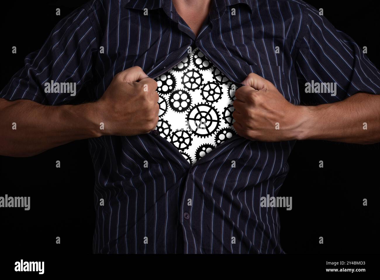 Man tears open shirt, under which gears are visible, symbolizing ...