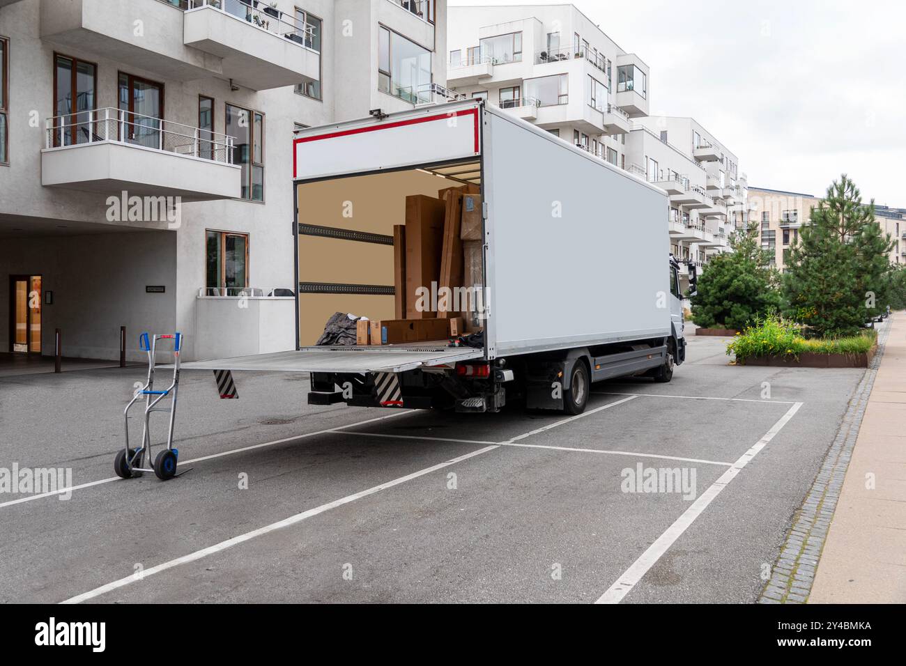 White empty delivery truck with tailgate open and goods in the cargo ...