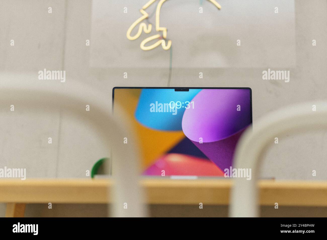 Open laptop, colorful desktop wallpaper. Concrete wall home interior ...