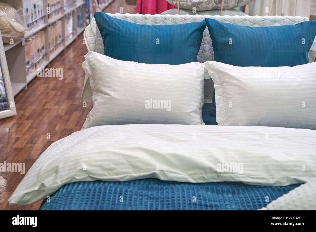 Cozy bedroom interior with blue and white bedding in home goods store ...