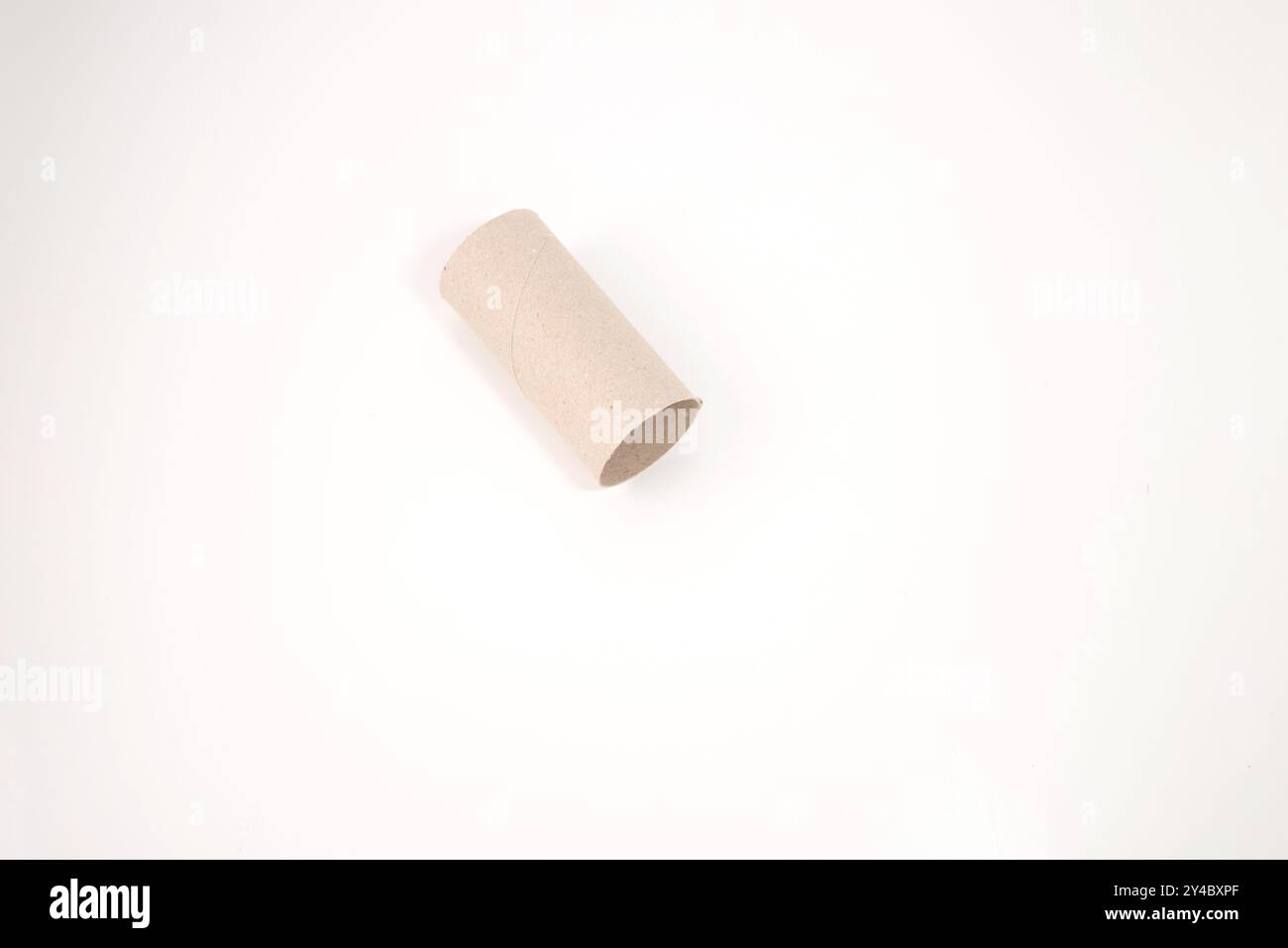 a single piece of brown toilet paper roll on a plain white background ...