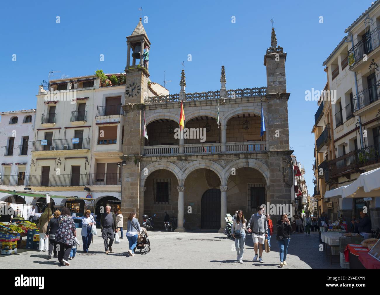 Lively square with historic building, clock tower and many people in ...