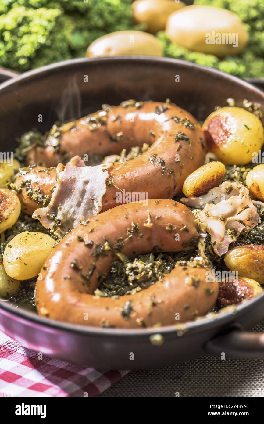 Kale with Bregenwurst sausage and roast potatoes Stock Photo - Alamy