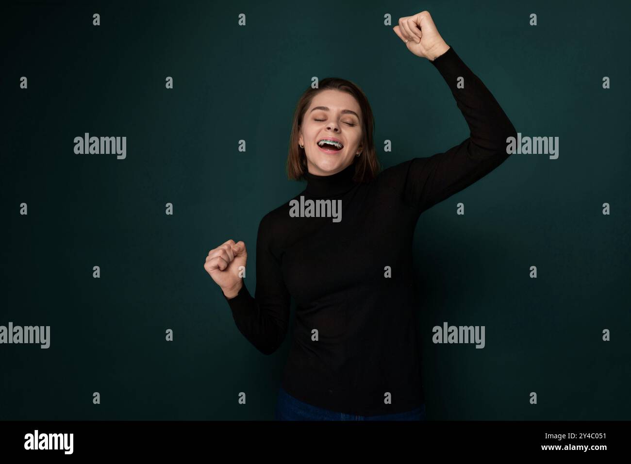 Woman in Black Shirt Holding Arms in the Air Stock Photo - Alamy