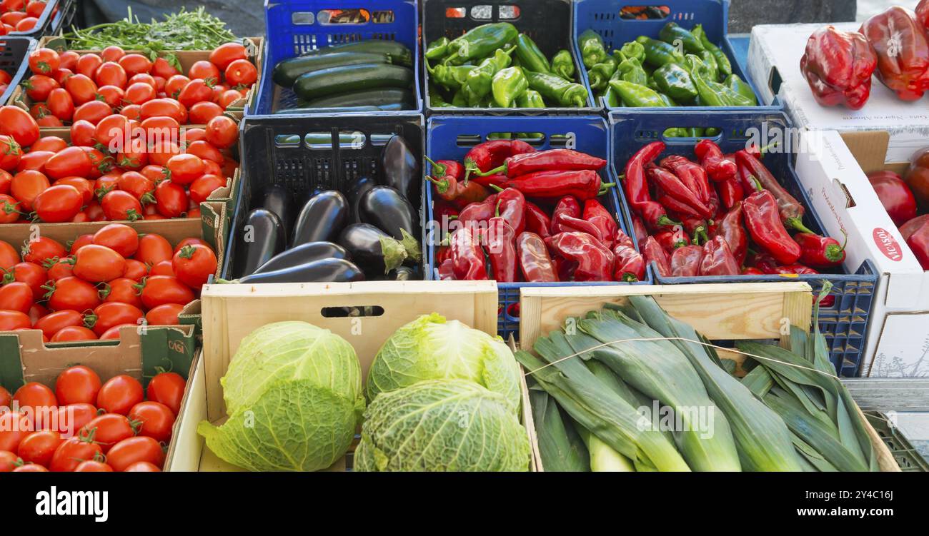 Market stall with a colourful selection of fresh vegetables such as ...