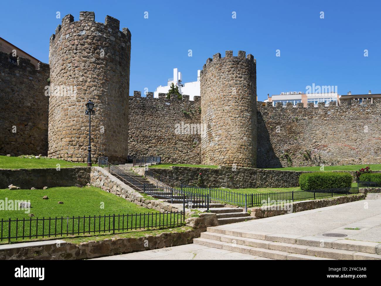 An old castle with massive stone walls and towers surrounded by ...