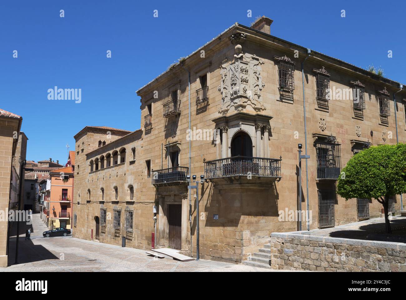 Historic sandstone city building with balcony and coat of arms under a ...