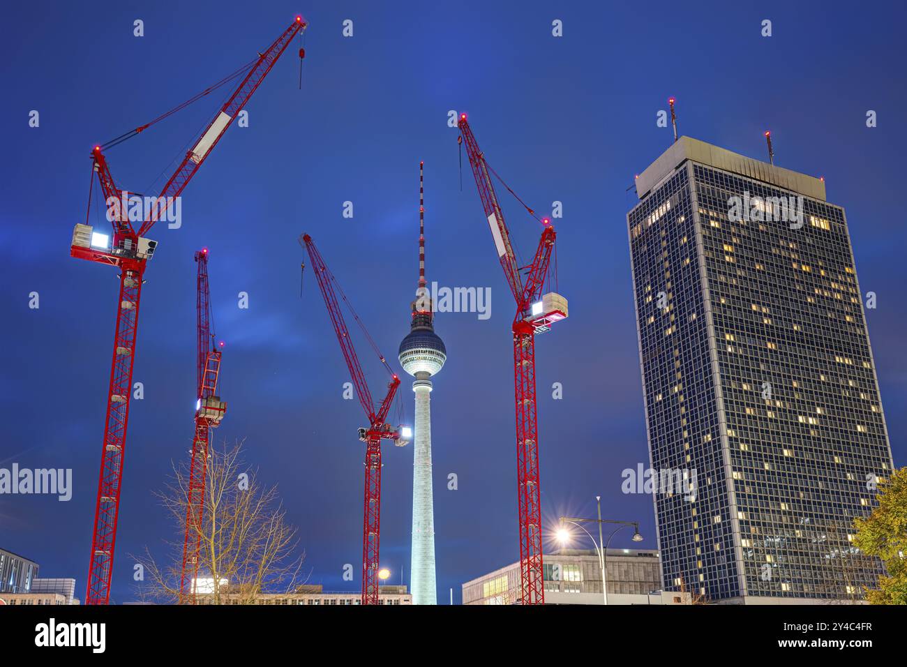 The famous Berlin television tower at night with a skyscraper and four ...