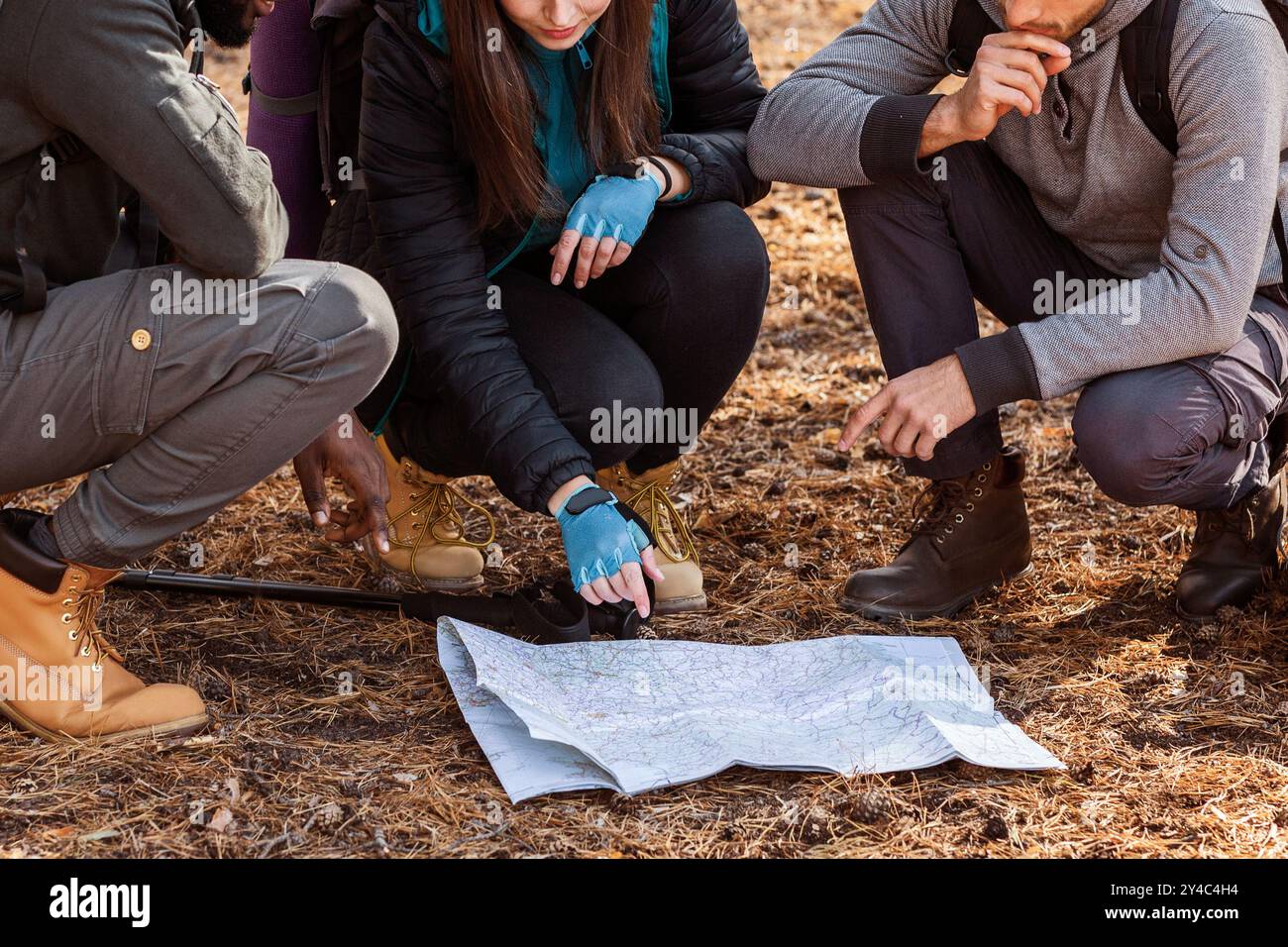 Confused hikers looking at map, lost in forest Stock Photo - Alamy