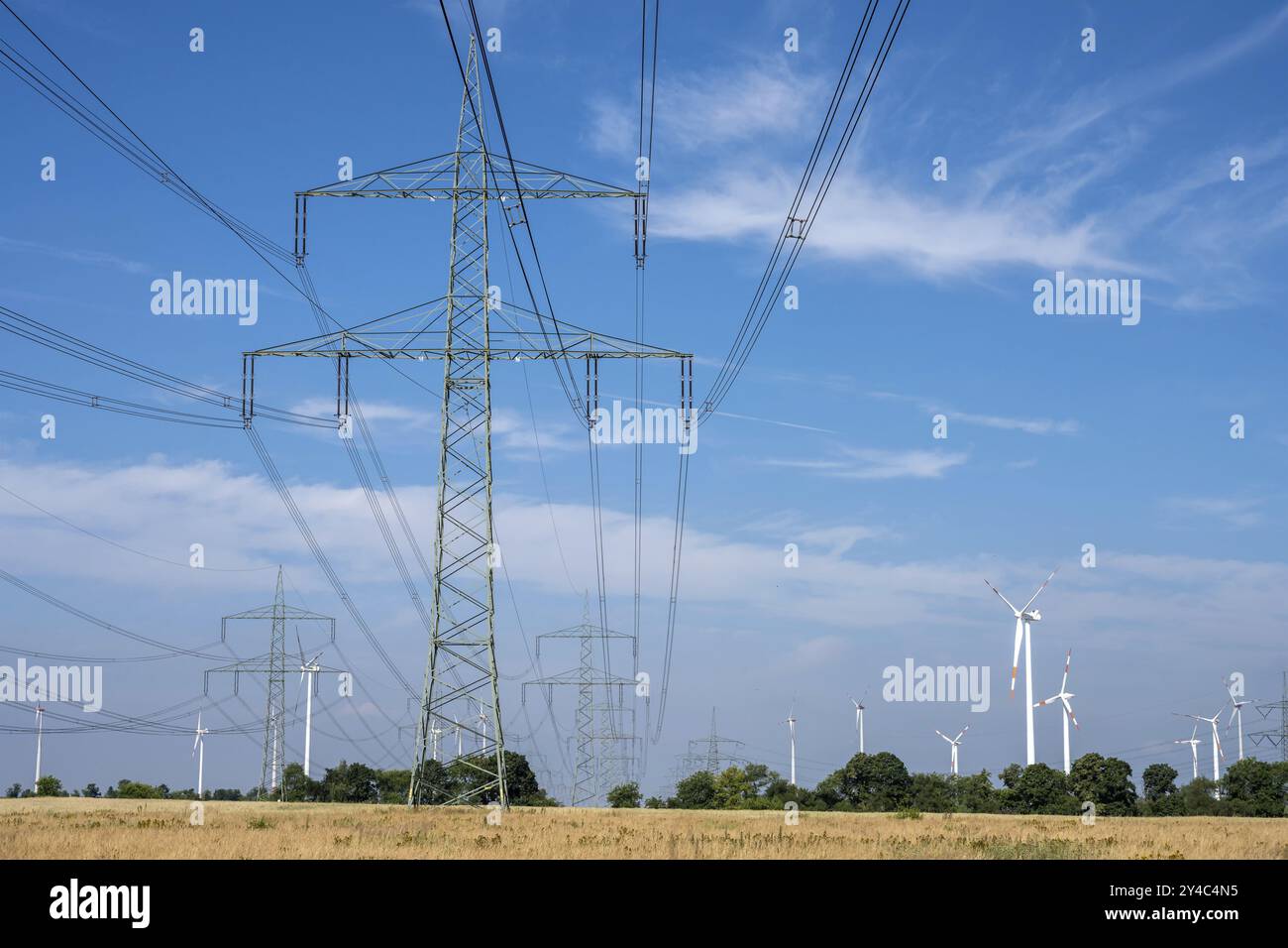 Electricity pylons, high-voltage power lines and wind turbines in ...