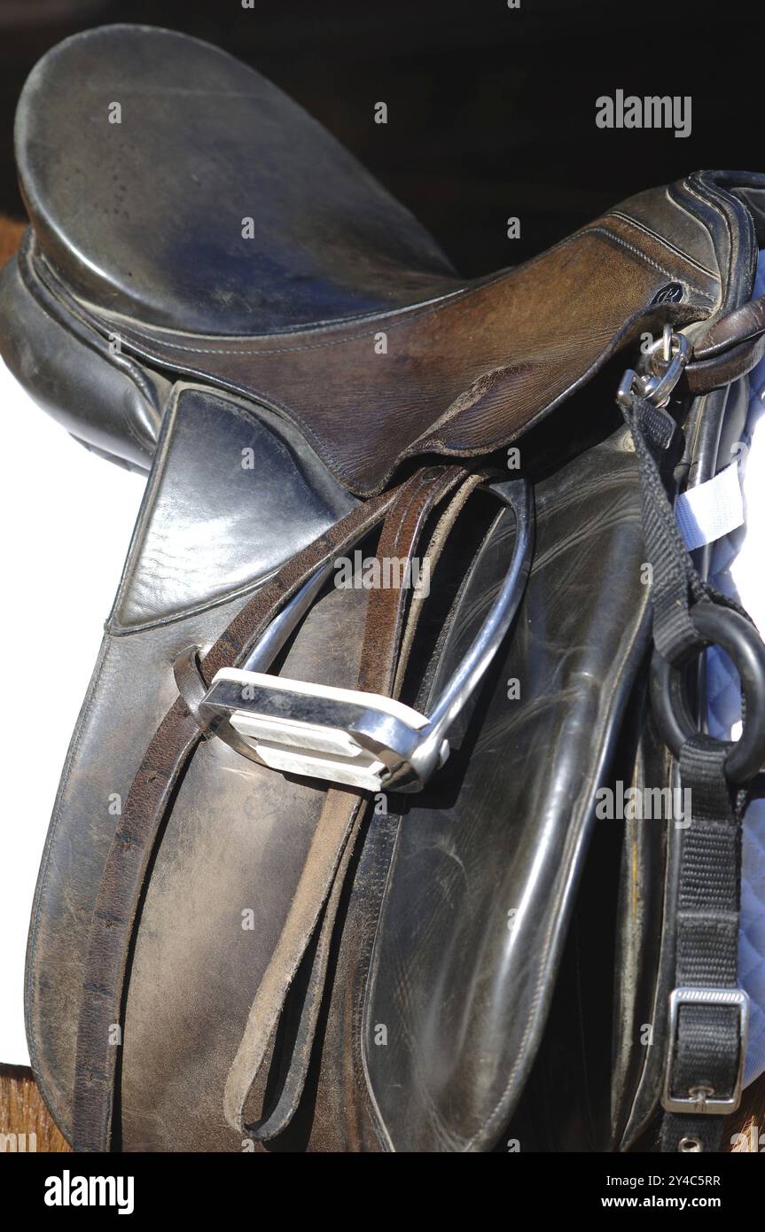 Old saddle with stirrups, rubber inlay Stock Photo - Alamy