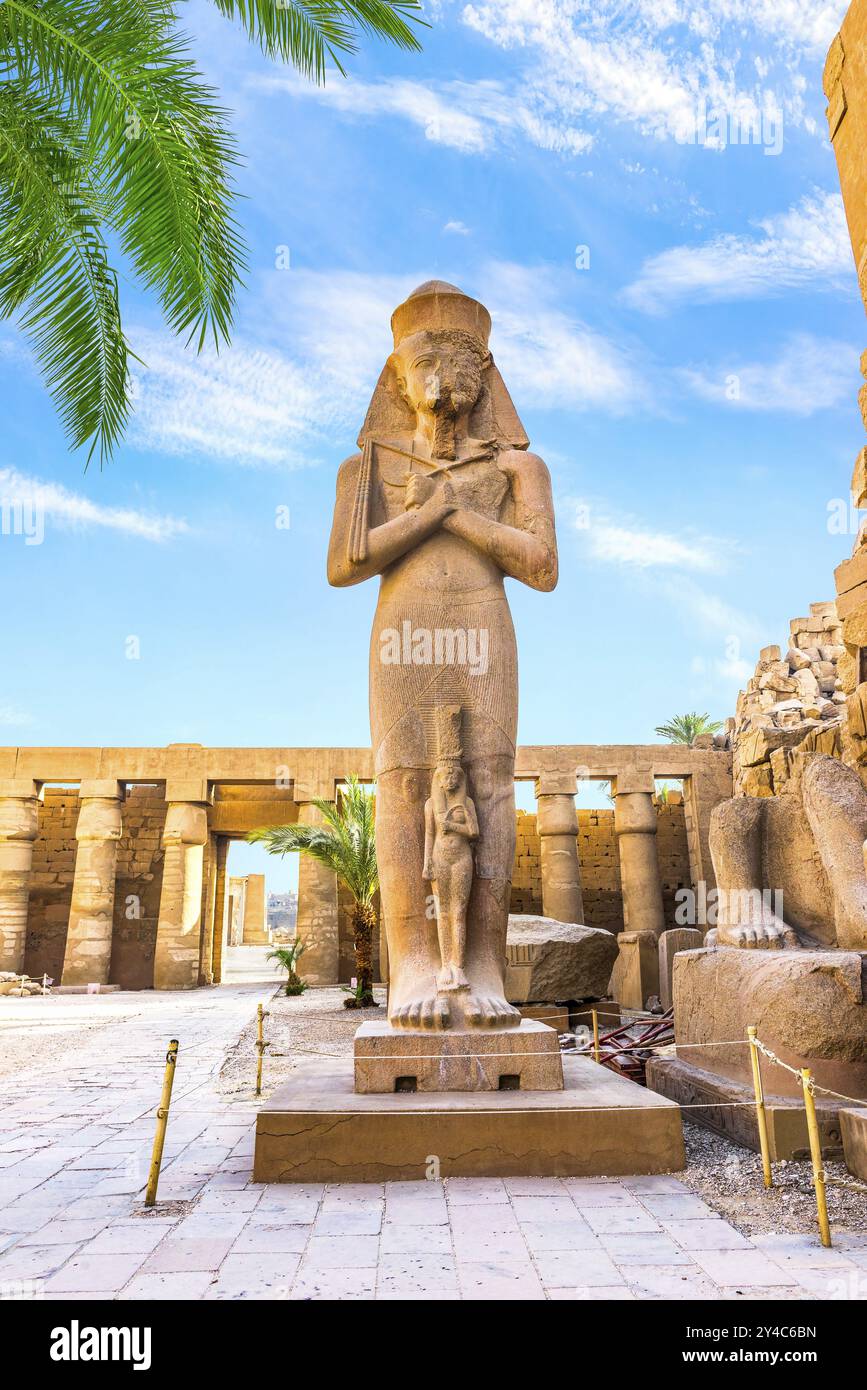 Statues of Ramses and his wife in Karnak temple Stock Photo - Alamy