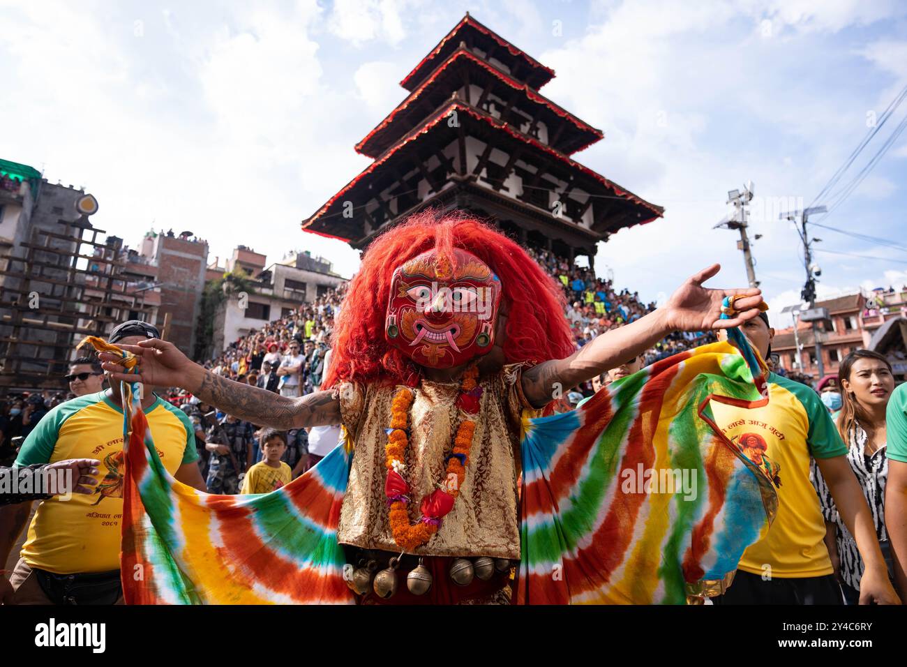 A masked dancer performs a traditional lakhe dance during a chariot procession for the Kumari, a ...