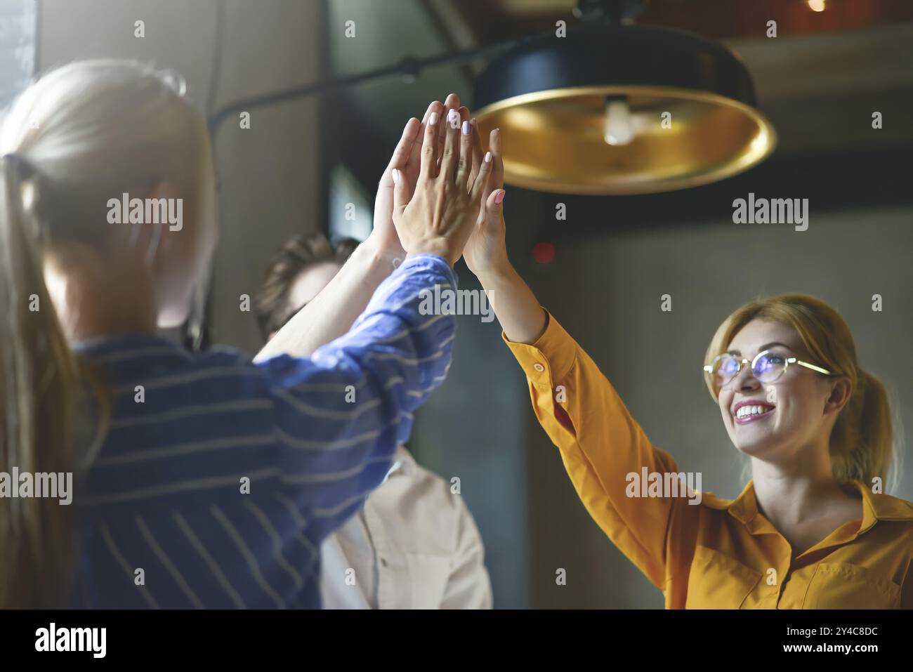 Close up top view of young business people putting their hands together. Stack of hands. Unity ...