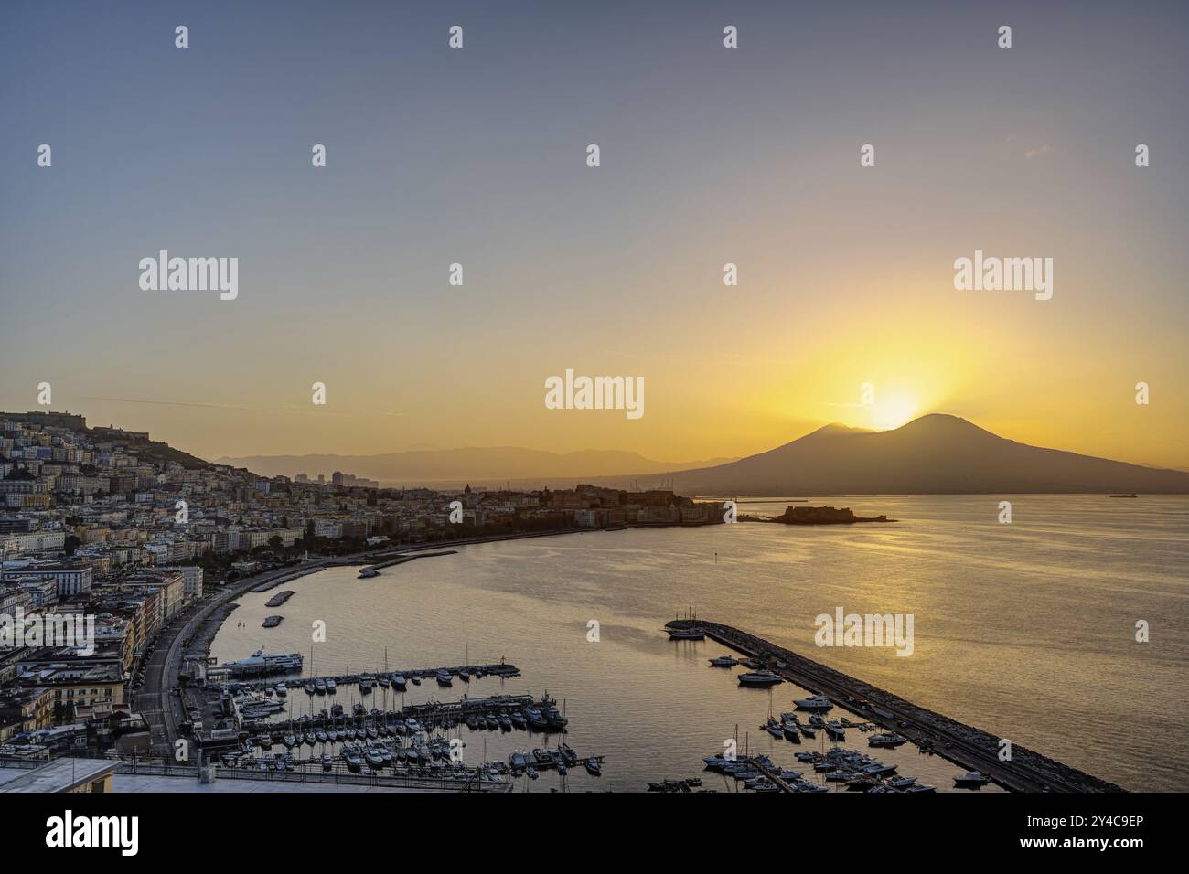 Naples and the Gulf of Naples in Italy with the rising sun directly ...