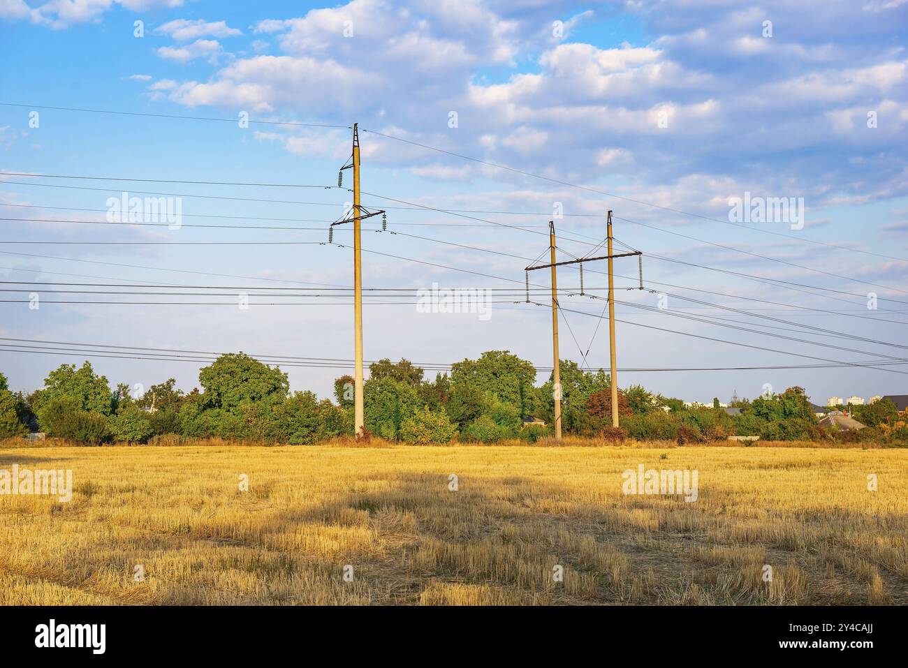 High electric poles on the field of mown wheat Stock Photo - Alamy