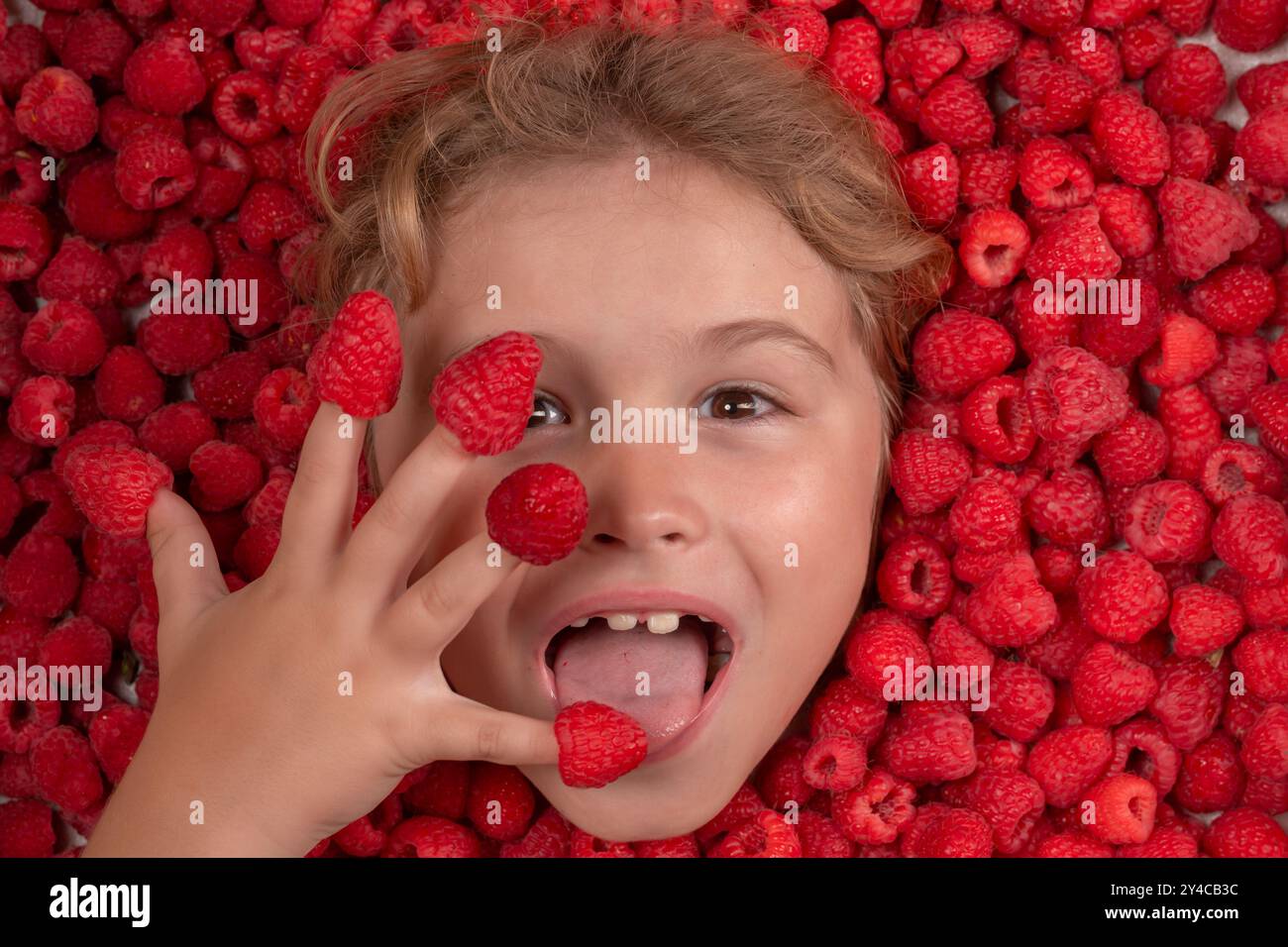Summer fruits. Raspberry isolated. Raspberries child face close up. Top ...