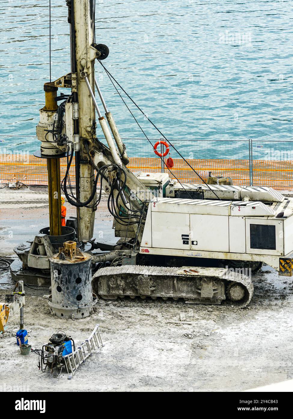 Installation of pile casings in the port quay, drilling rig machine ...