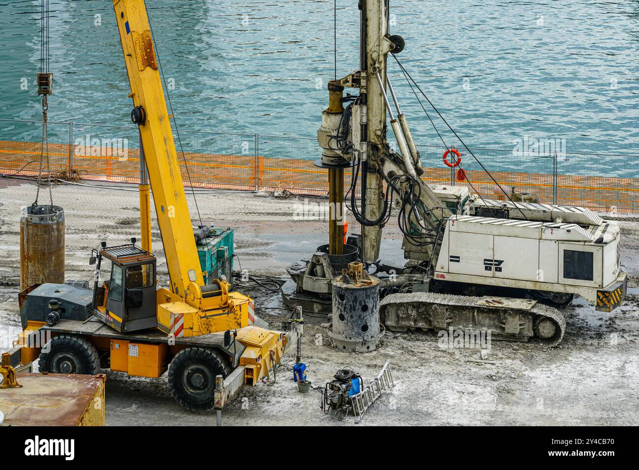 Installation of pile casings in the port quay, drilling rig machine ...