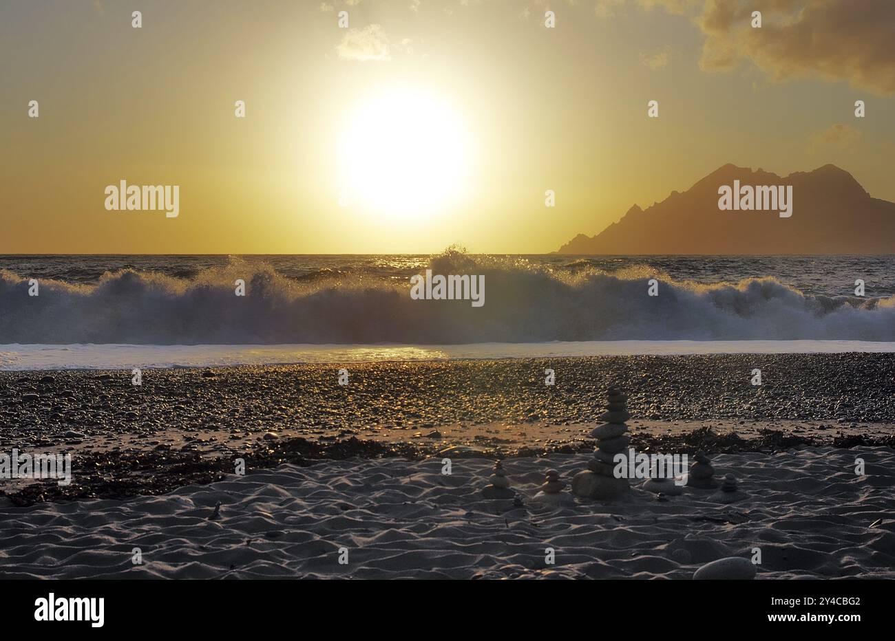 Land art in front of surf waves at sunset on Porto beach, Corsica Stock ...