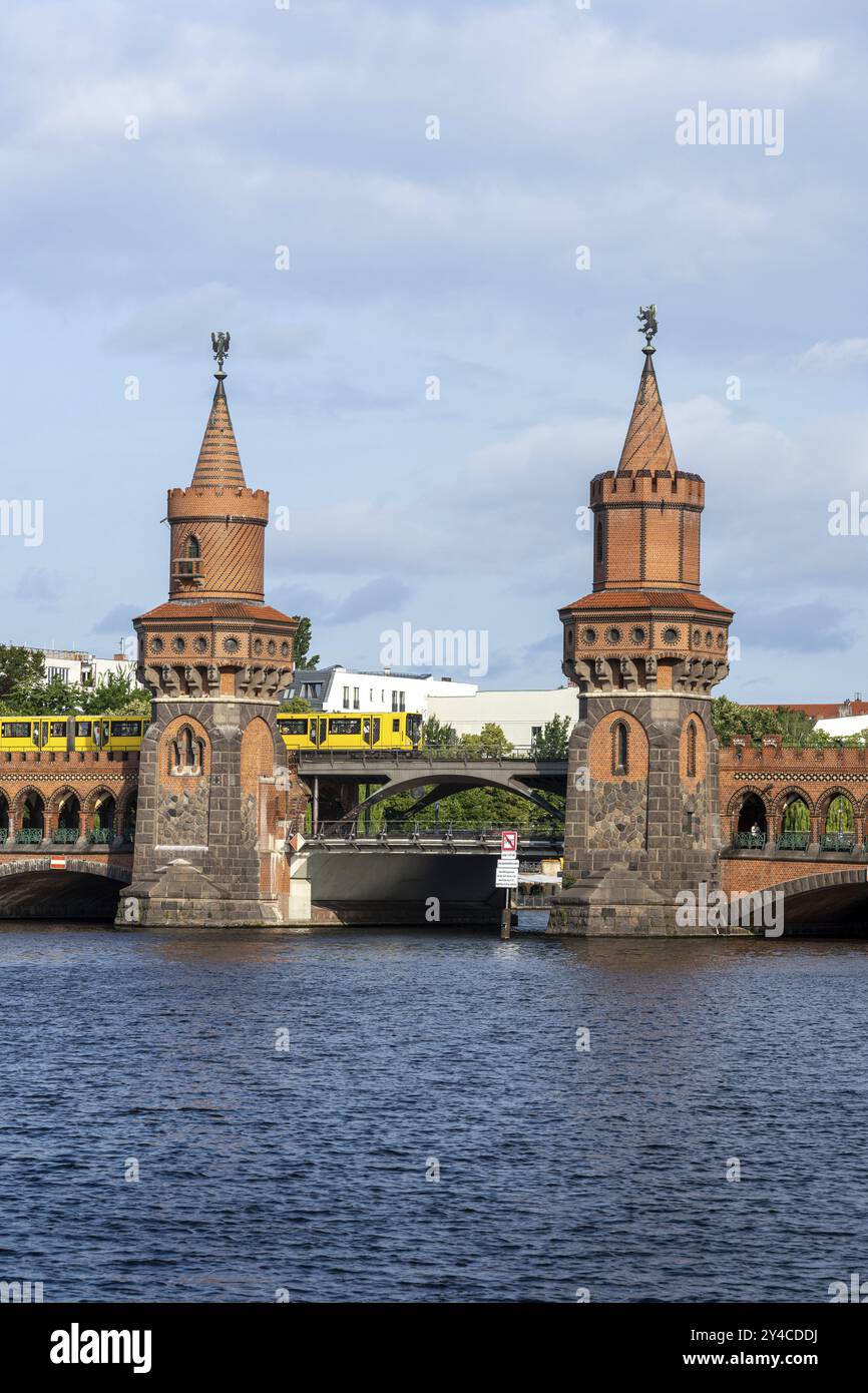The beautiful Oberbaum Bridge in Berlin with a yellow underground train ...
