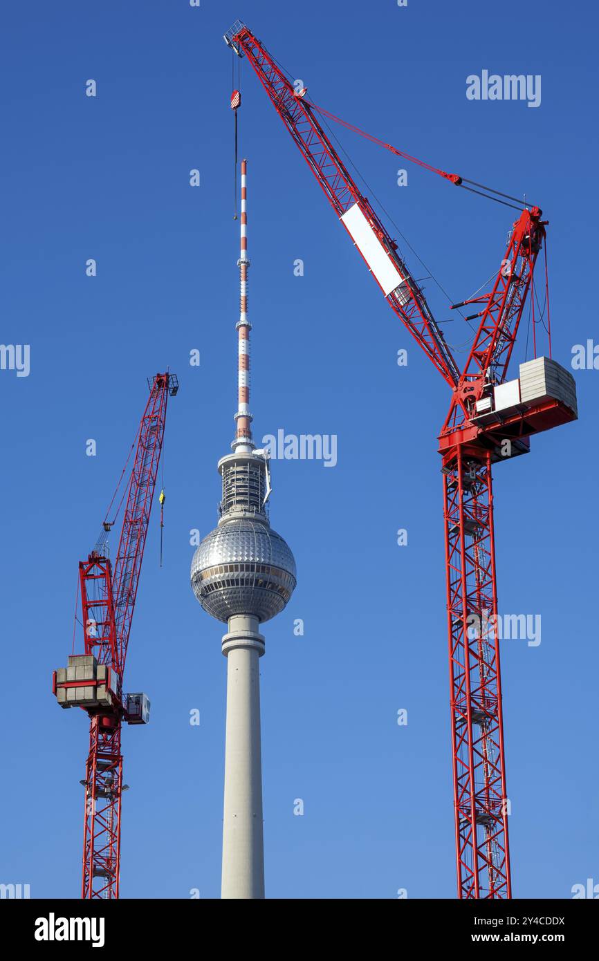 The famous Berlin television tower with two red tower cranes Stock ...