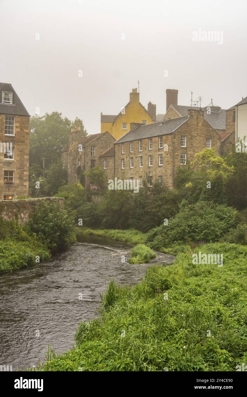 Image of a misty river surrounded by historic brick buildings and lush ...