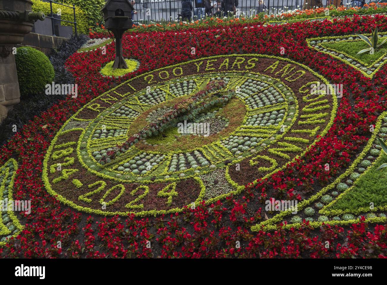Detailed floral clock with colourful flowerbed and text to celebrate an ...