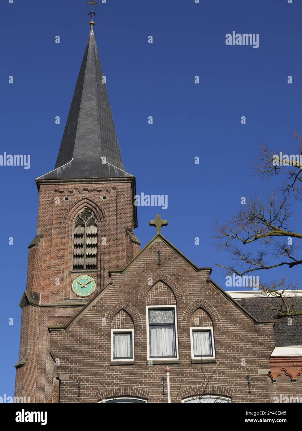 Brick church building with clock tower and triangular windows under a ...