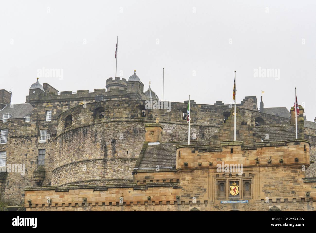 A medieval castle with defence towers and stone walls, flagged and ...