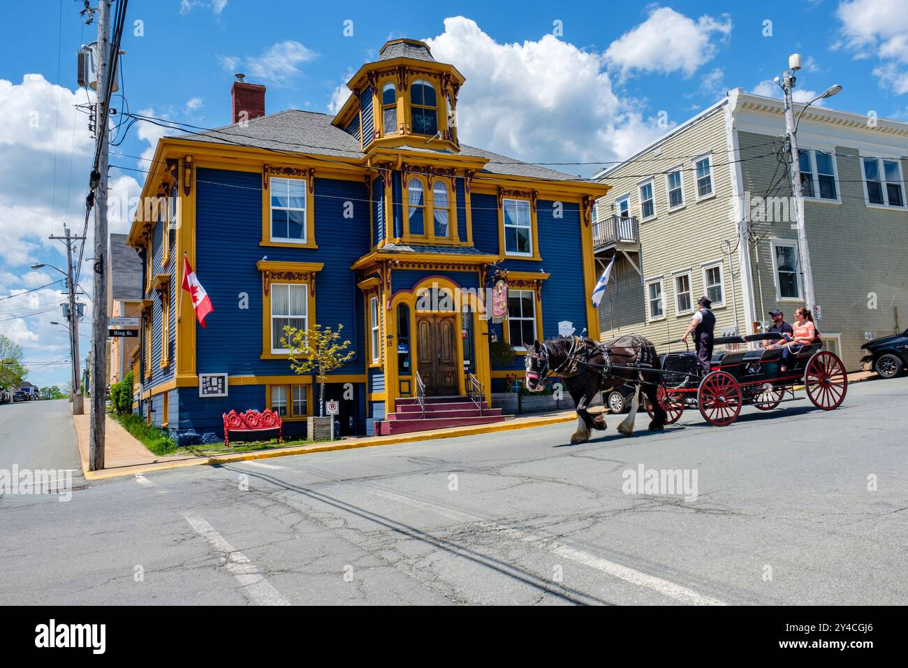 Colourful historical houses, tourists sightseeing on a horse drawn ...