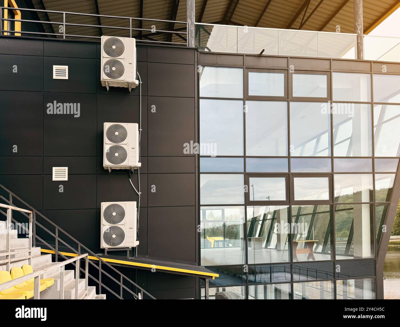 Air conditioning units on the side of a modern steel-framed building ...