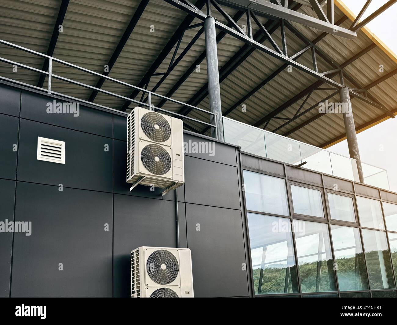 Commercial HVAC system installed on building exterior with glass, steel ...