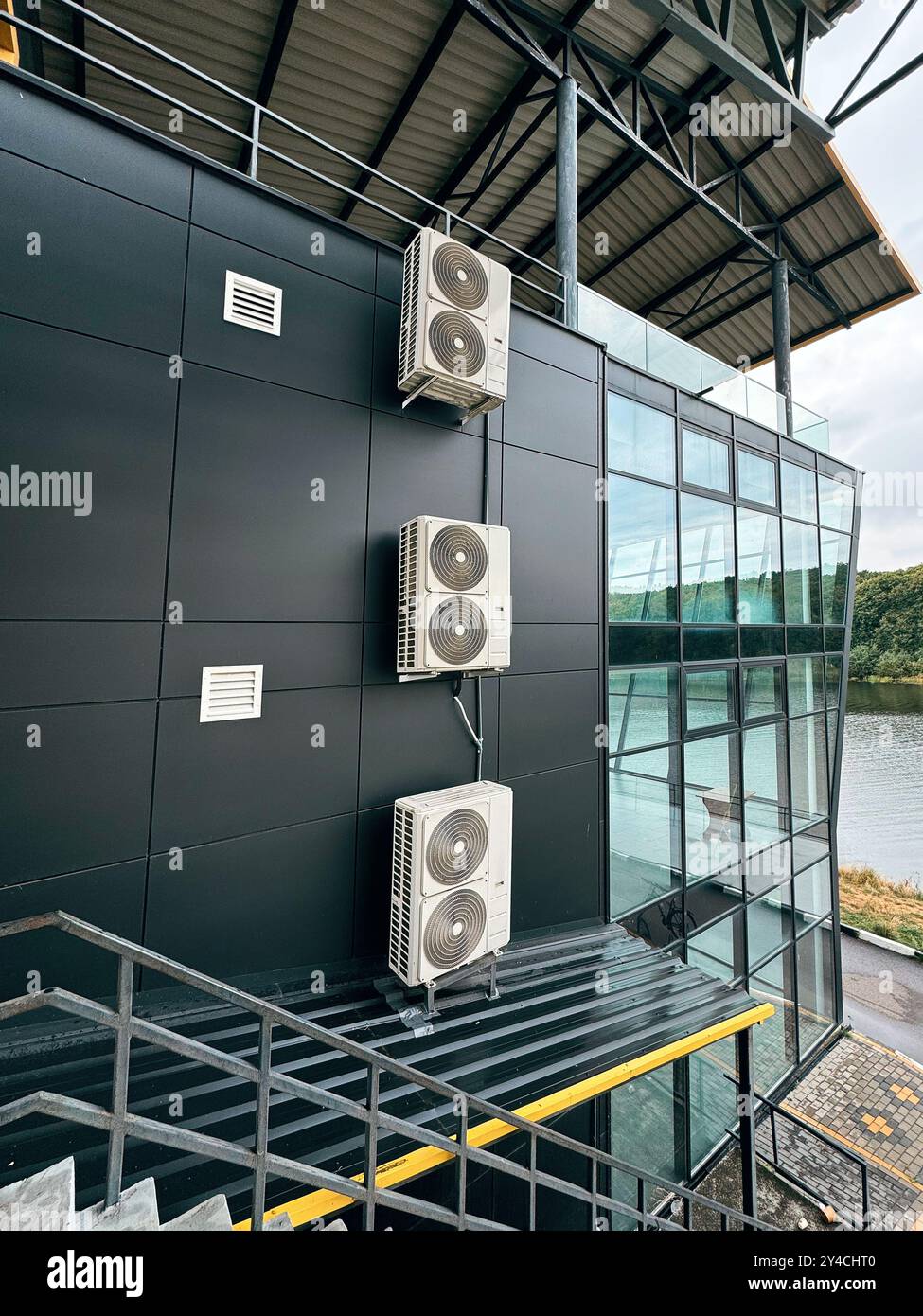 Commercial HVAC system installed on building exterior with glass, steel ...