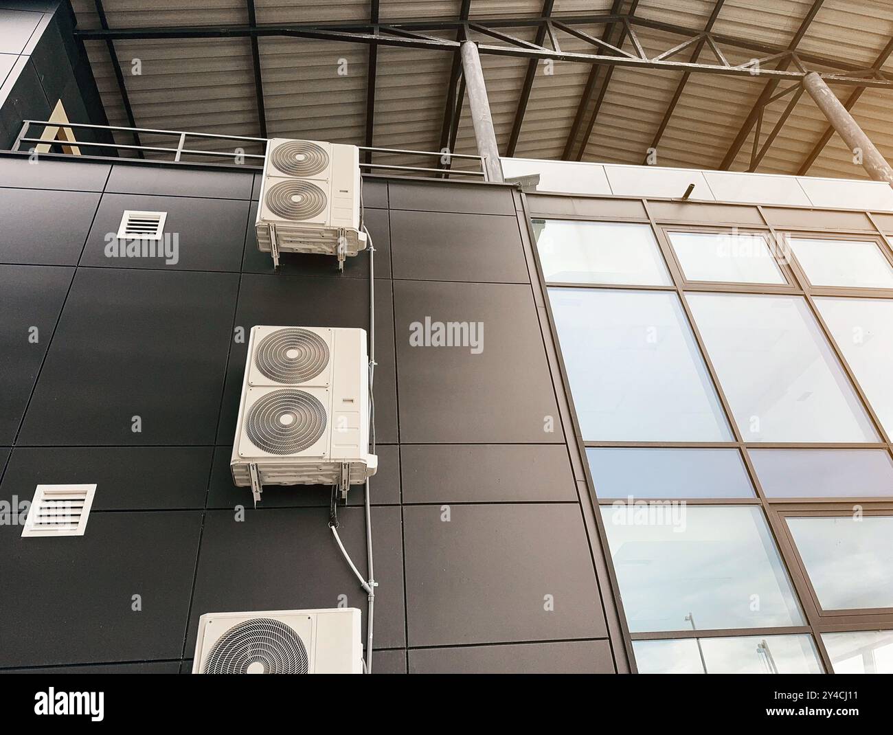 Modern building with outdoor HVAC system. Sun rays Stock Photo - Alamy