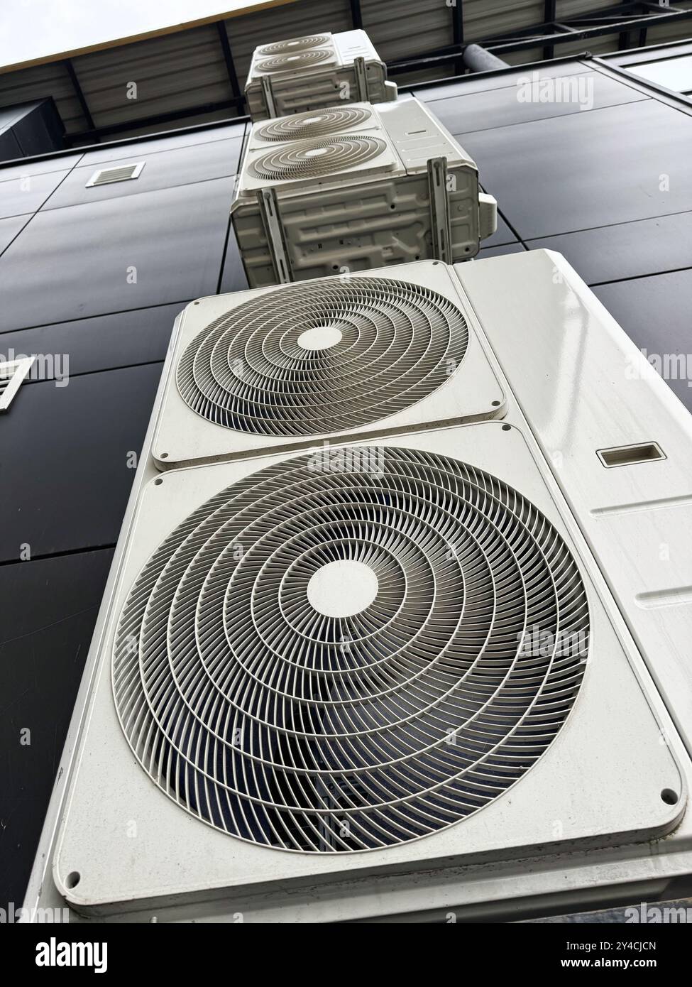 Air conditioning units attached to industrial building with steel ...
