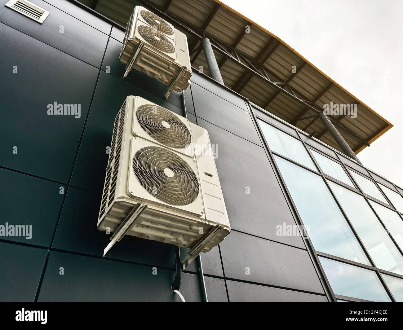Air conditioning units attached to industrial building with steel ...
