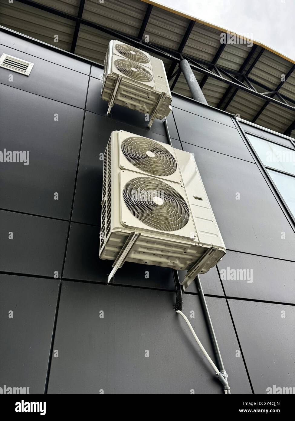 Air conditioning units attached to industrial building with steel ...