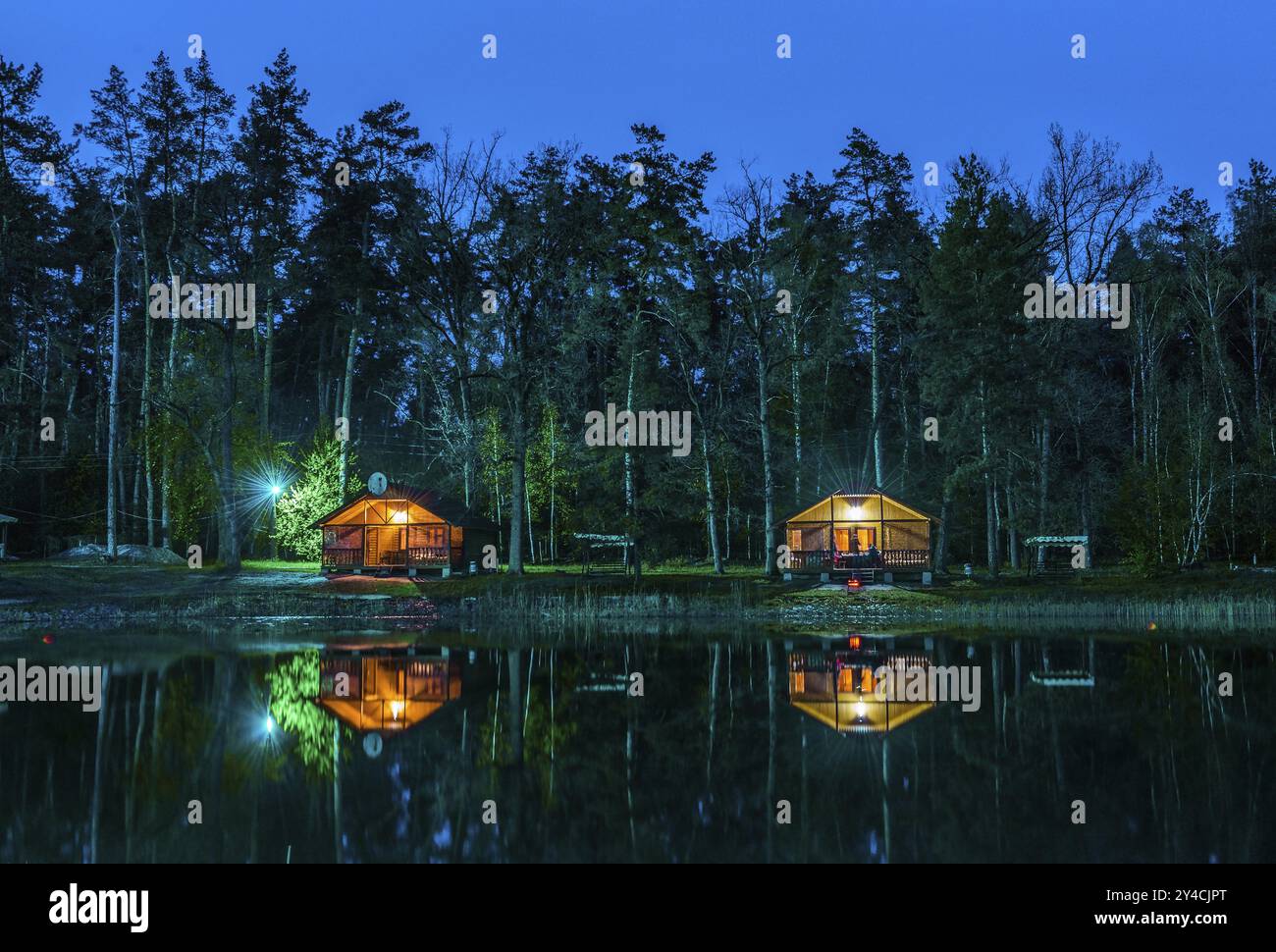 Small wooden cottages in forest at night Stock Photo - Alamy