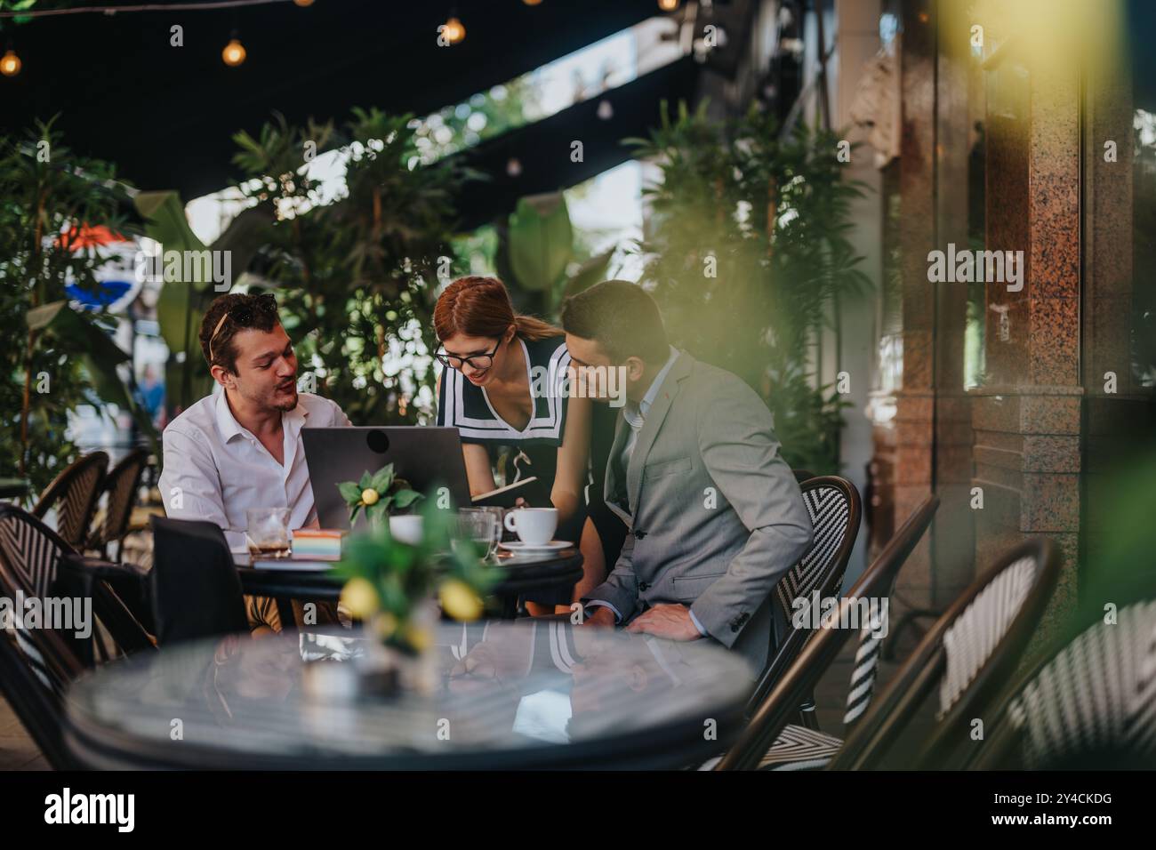 Businesspeople having a collaborative meeting at an outdoor cafe ...