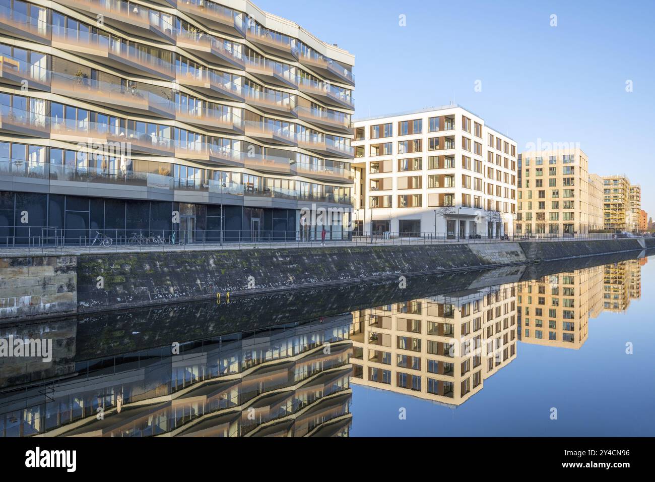 Modern apartment blocks in Berlin with a reflection in a small canal ...