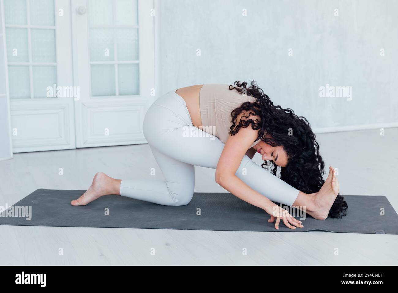 Relaxe harmonious beautiful brunette woman yoga instructor standing in ...