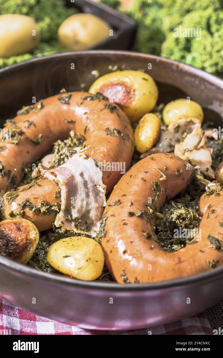 Kale with Bregenwurst sausage and roast potatoes Stock Photo - Alamy