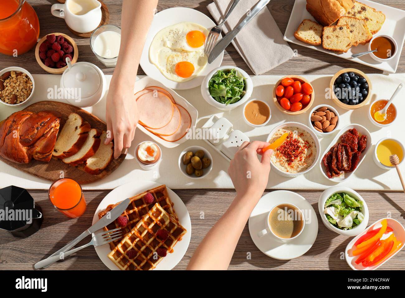 People having breakfast at wooden table, top view Stock Photo - Alamy