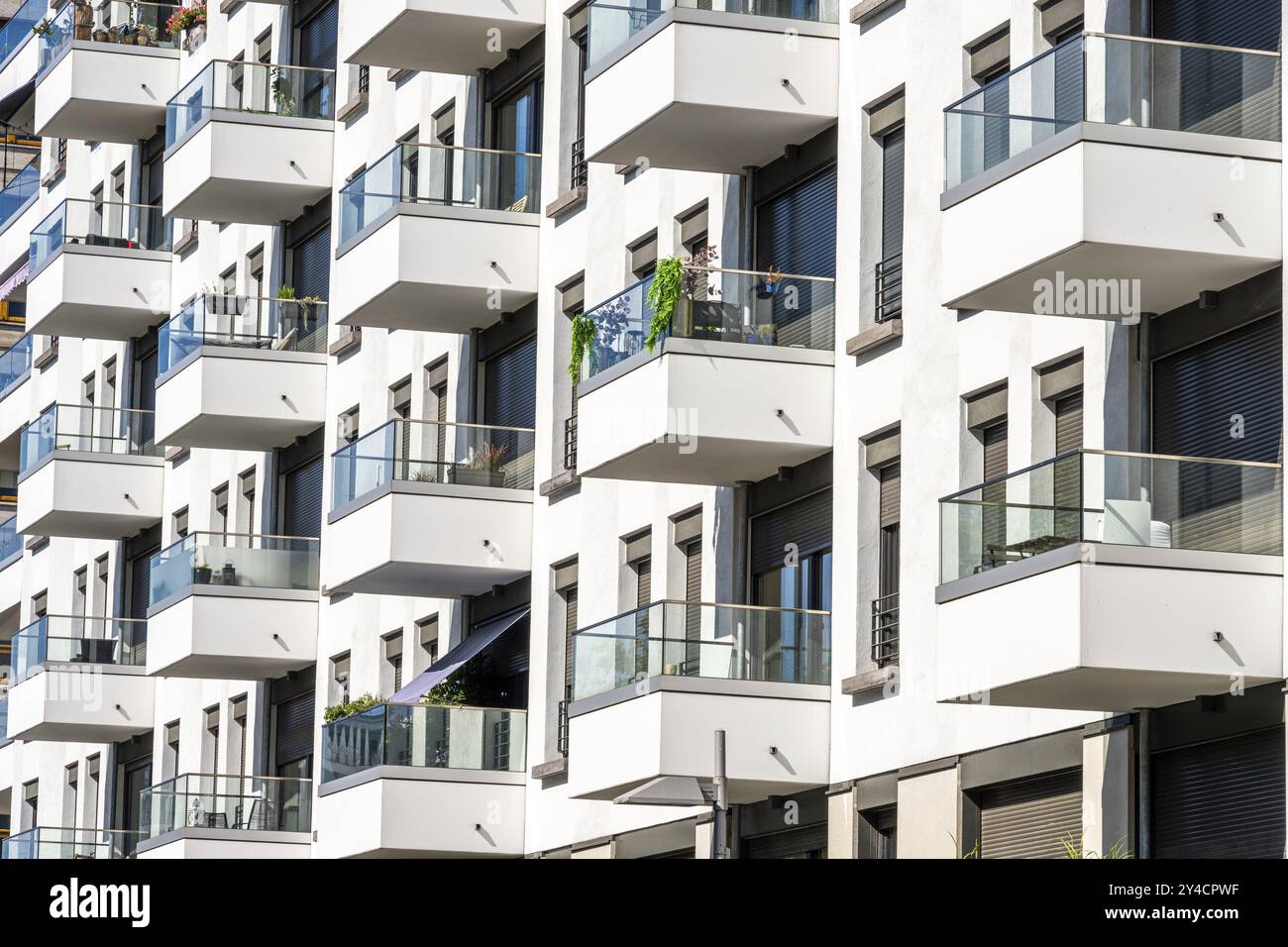 Facade of a white modern apartment block with small balconies in Berlin ...