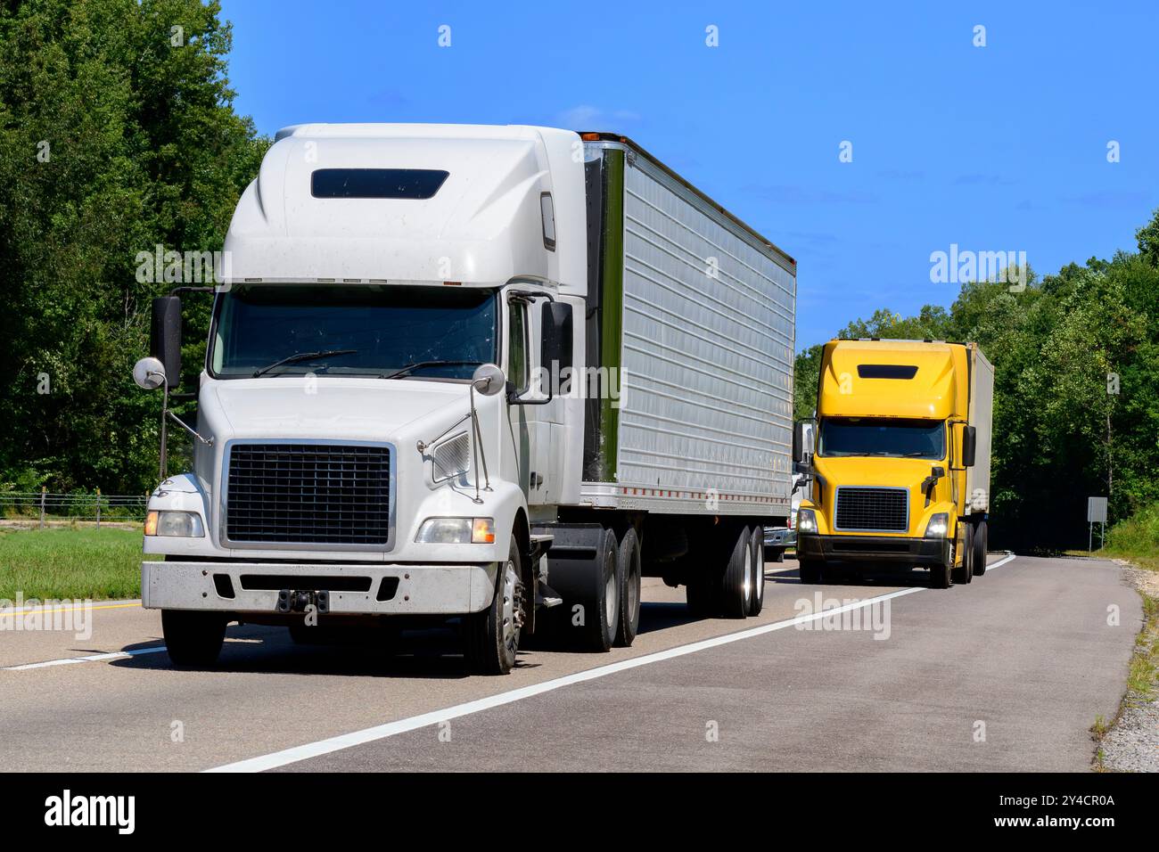 Horizontal shot of eighteen wheeler trucks on an interstate near the ...