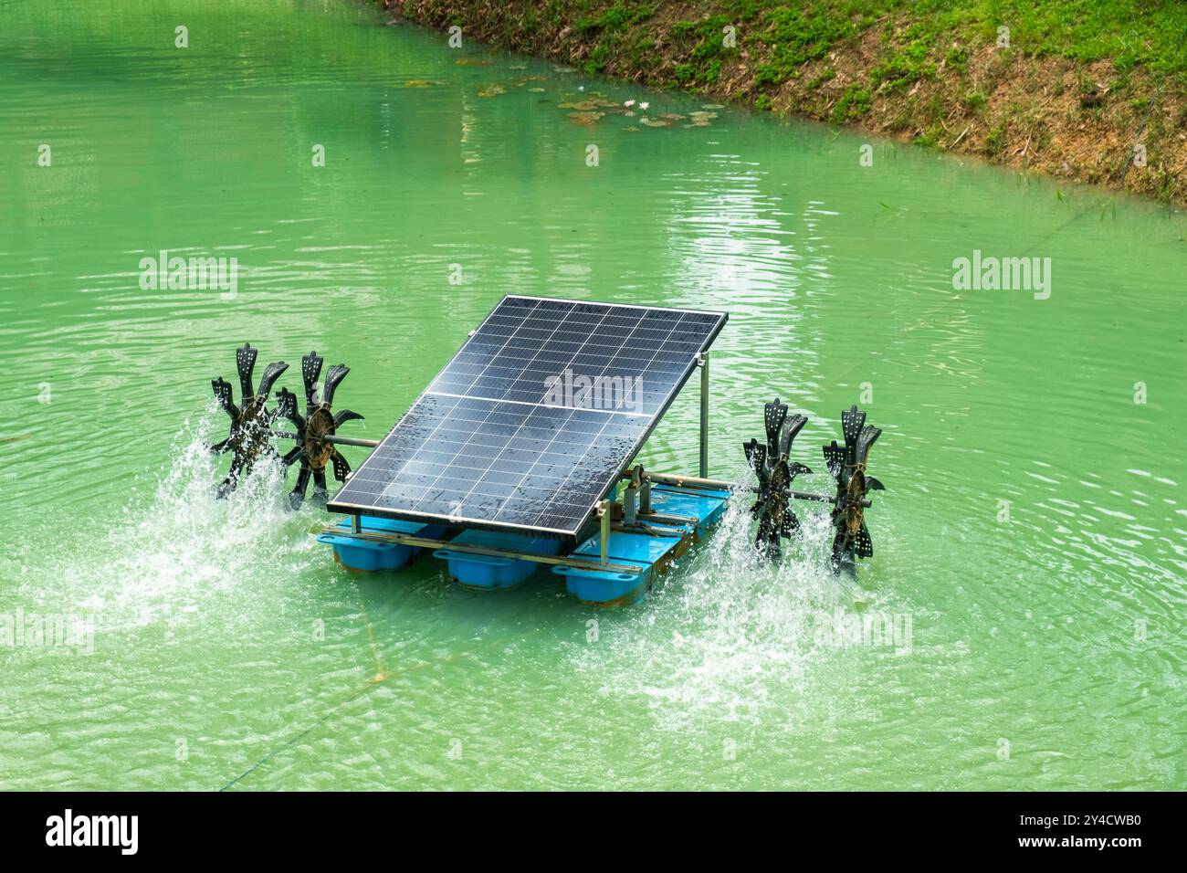 Solar-powered water aerator system with rotating paddles in a pond for ...