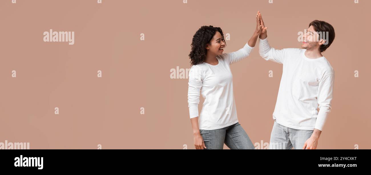Loving Multiracial Couple Giving High Five To Each Other, Clapping ...