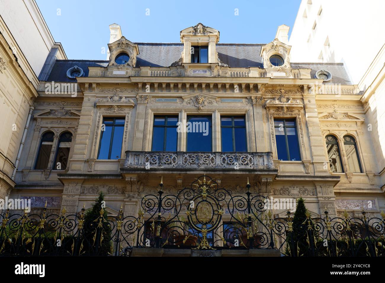 The facade of traditional French house with typical balconies and ...